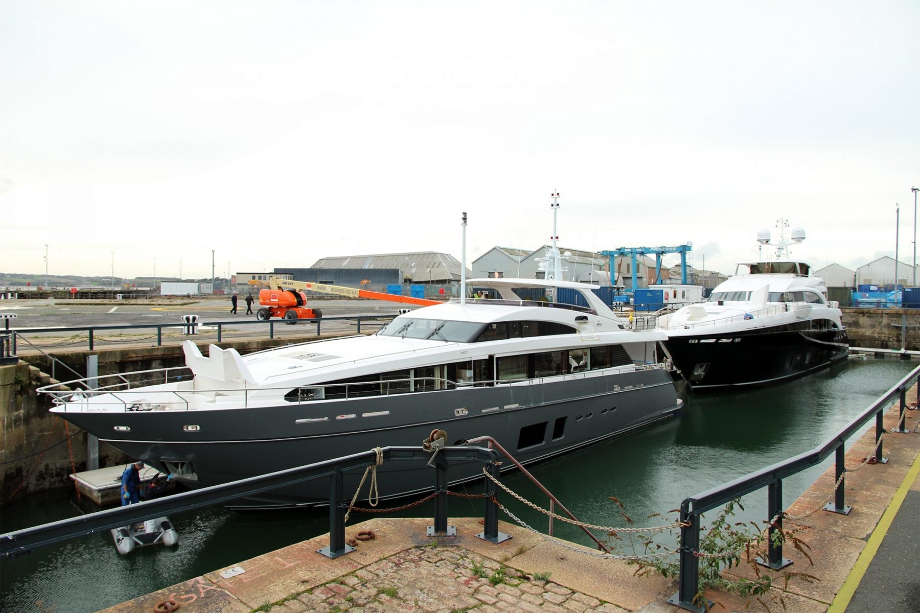 Two M-Class Luxury Princess Motor Yachts Lying in Shallow Dock